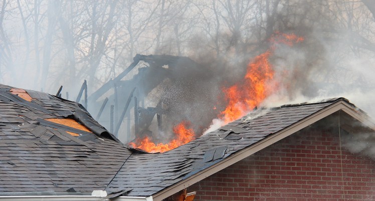 With help from neighbors, woman escapes home fire as attic burns